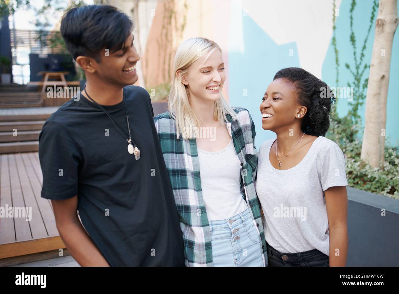 Three diverse friends laughing talking hi-res stock photography and ...