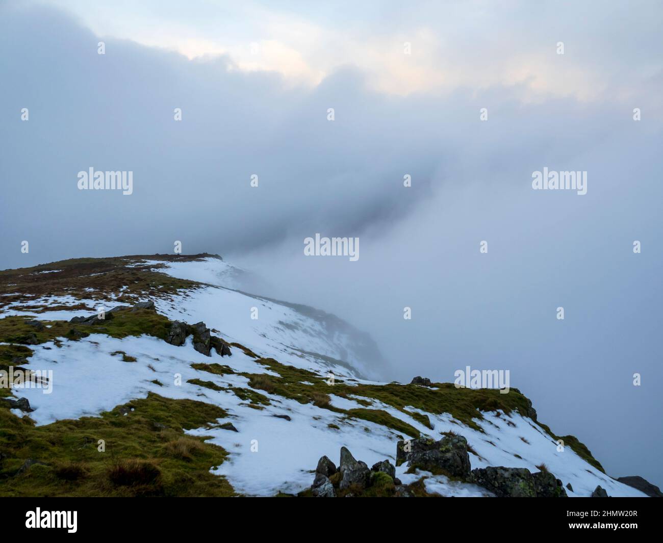 Cloud and mist clinging to the summit of Red Screes at dawn, Lake ...