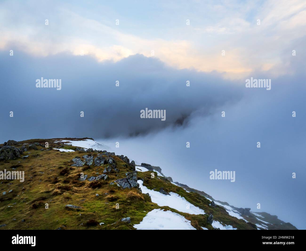 Cloud and mist clinging to the summit of Red Screes at dawn, Lake ...