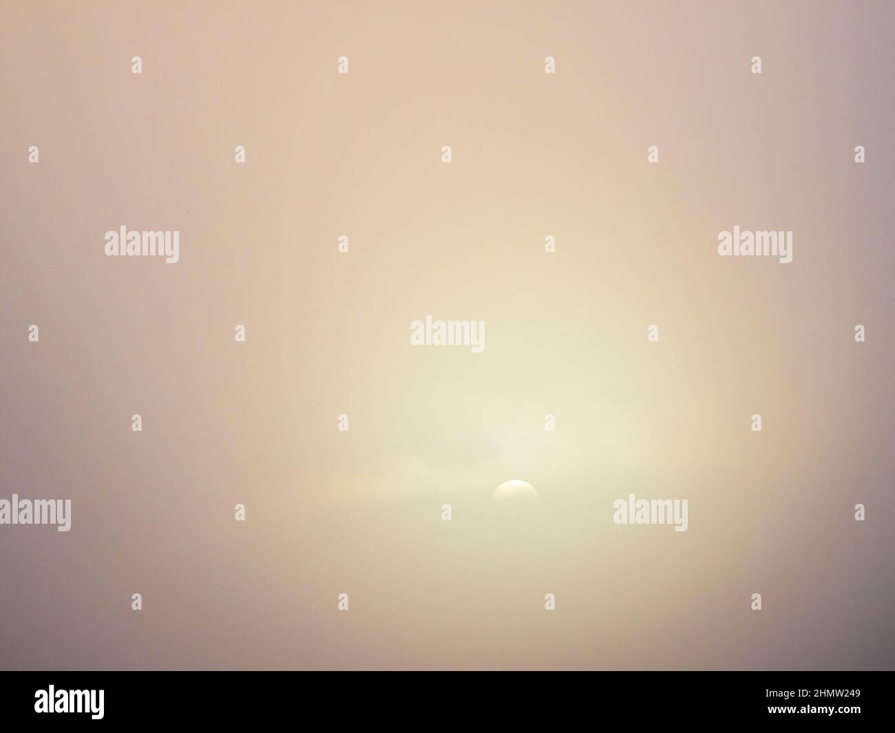 The sun setting through mist, Lake District, UK Stock Photo - Alamy