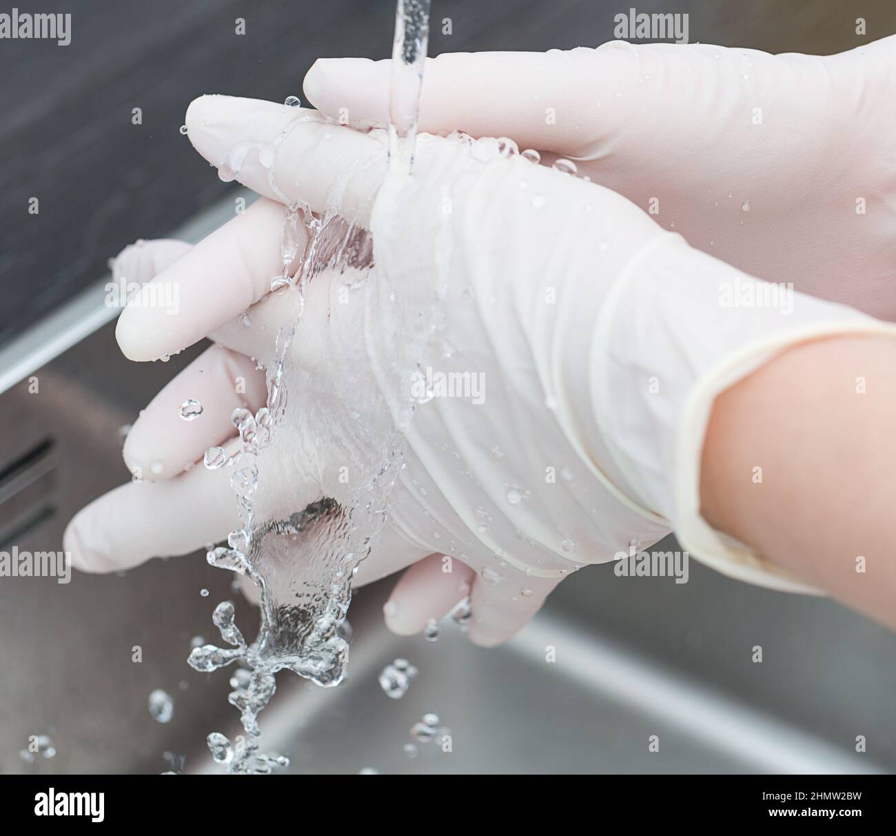 Dentist helper Washing hands with One-time gloves Stock Photo - Alamy