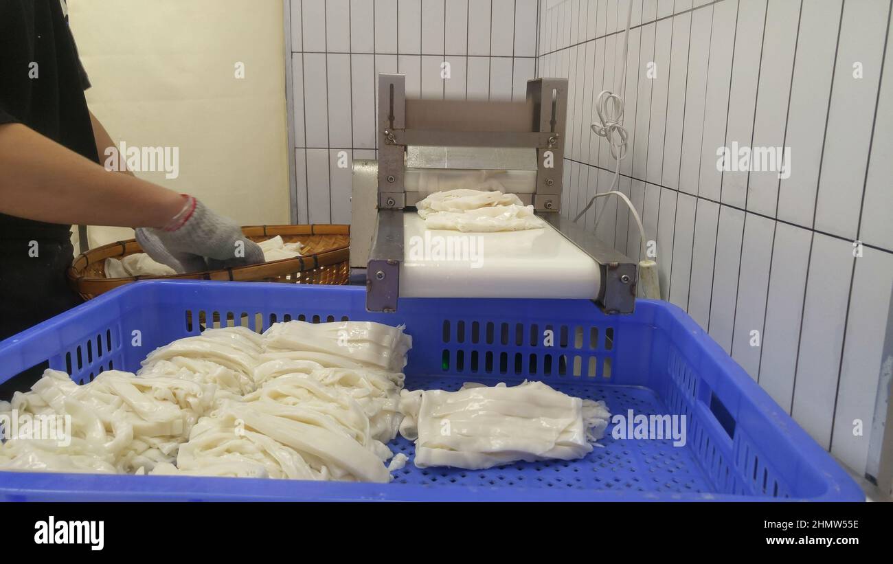 Traditional Chinese cuisine, rice noodles, is being processed Stock ...