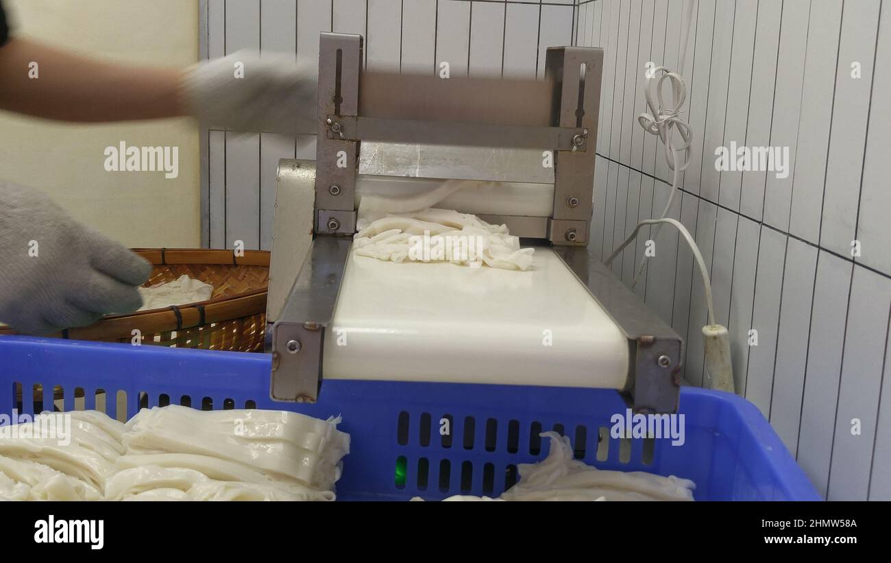 Traditional Chinese cuisine, rice noodles, is being processed Stock ...