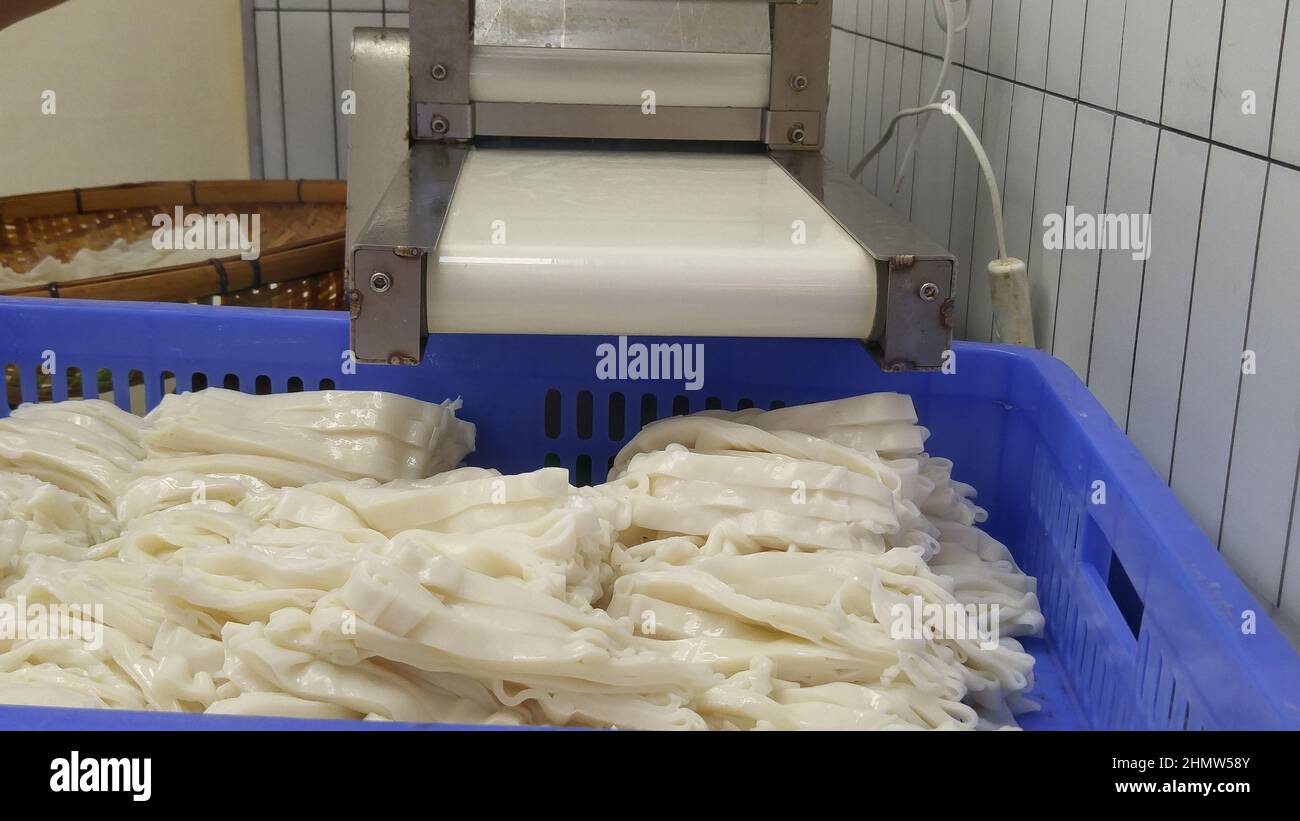Traditional Chinese cuisine, rice noodles, is being processed Stock ...