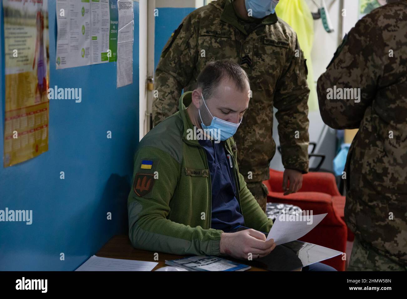 A soldier receives medical paperwork on February 9, 2022, at the 66th ...