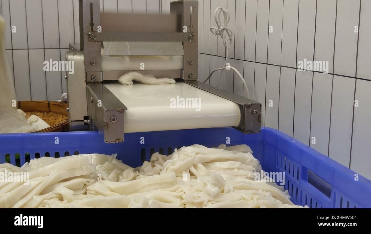 Traditional Chinese cuisine, rice noodles, is being processed Stock ...