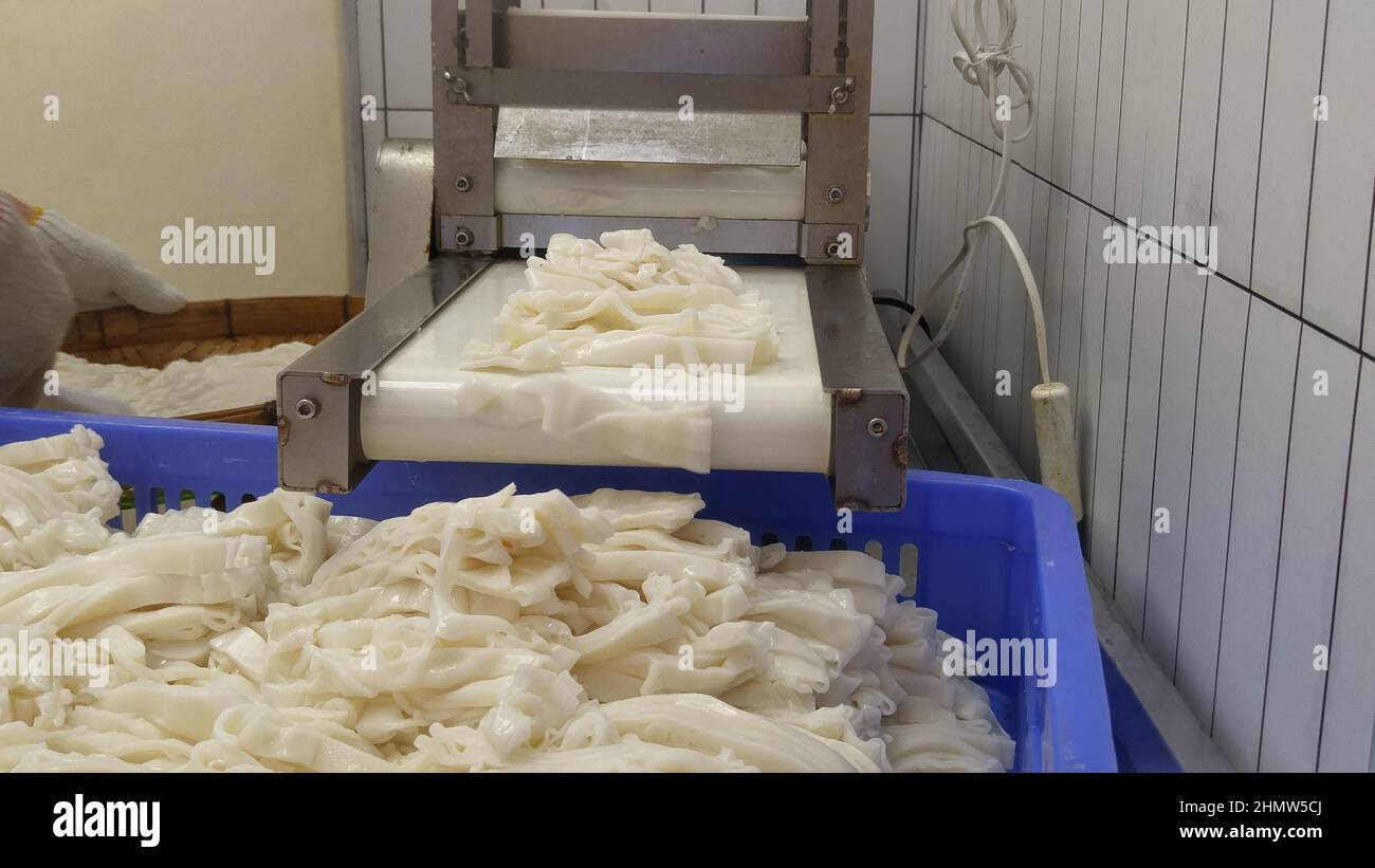 Traditional Chinese cuisine, rice noodles, is being processed Stock ...