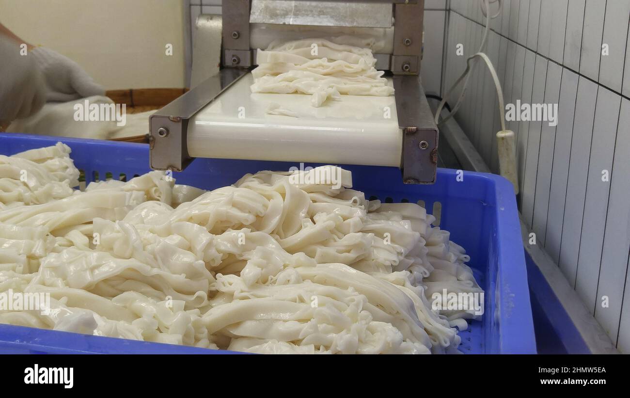 Traditional Chinese cuisine, rice noodles, is being processed Stock ...