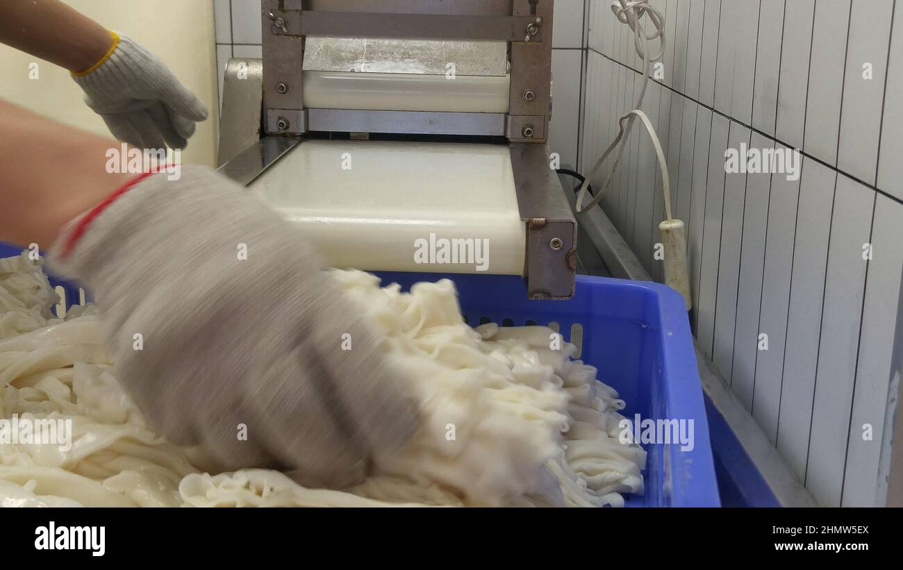 Traditional Chinese cuisine, rice noodles, is being processed Stock ...