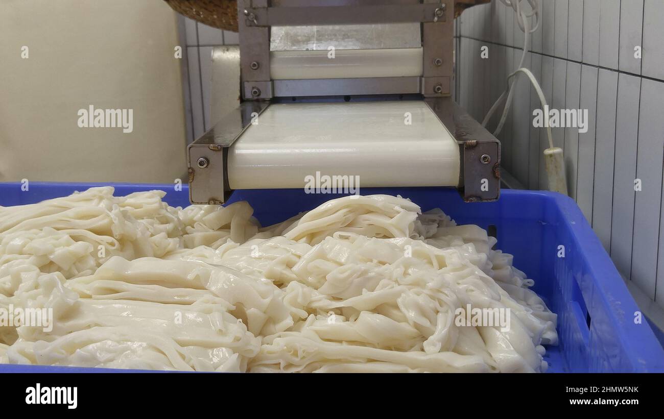 Traditional Chinese cuisine, rice noodles, is being processed Stock ...
