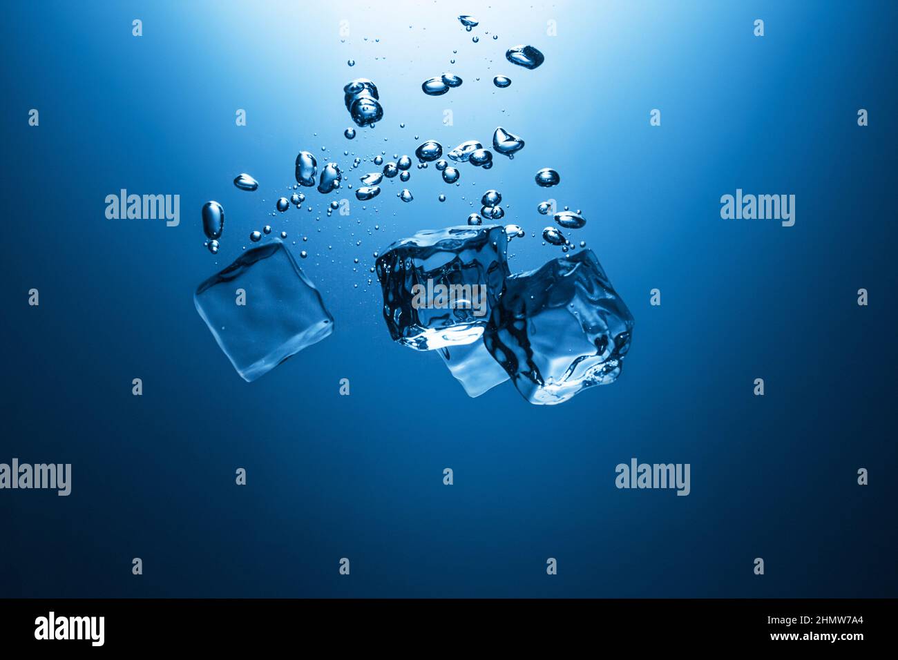 Falling ice cubes in water Stock Photo - Alamy