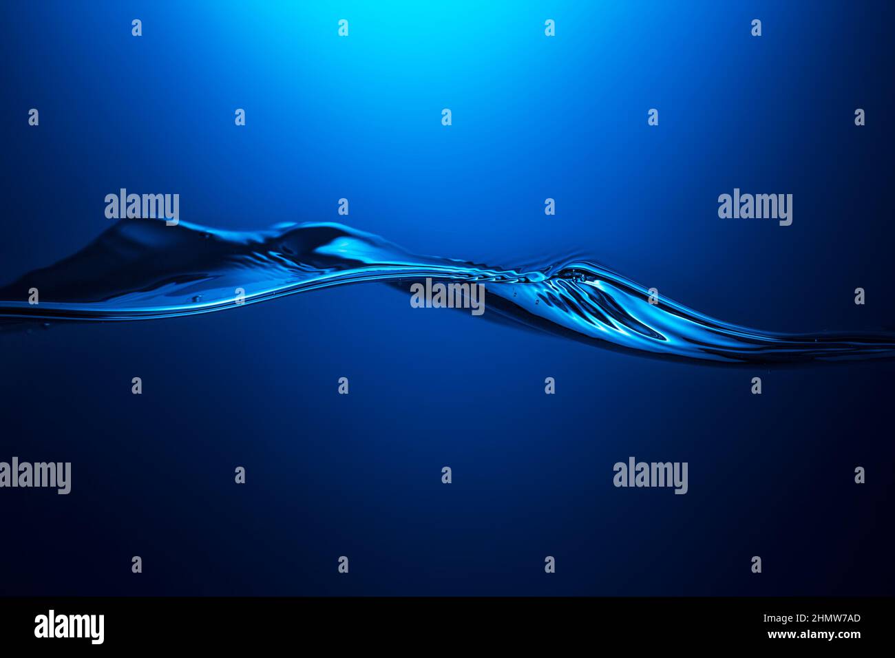 A blue water wave on dark blue background. Taken in studio with a 5D ...