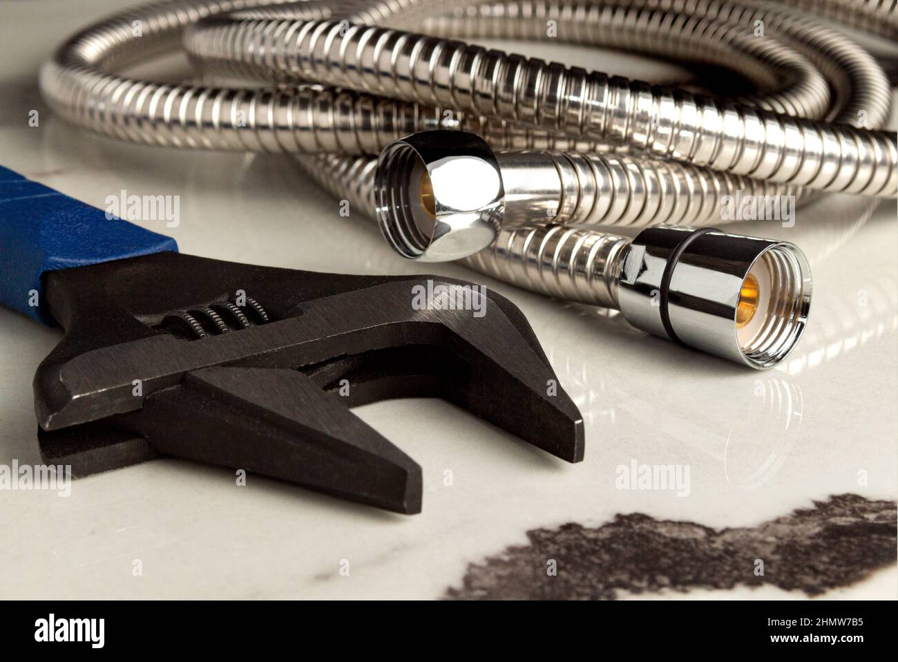 New shower hose and new sliding key. Closeup side view on white marble ...