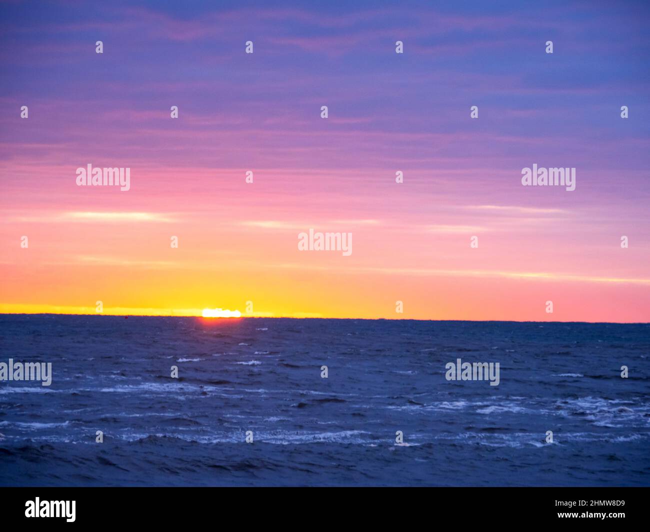 The sun rising at dawn over the North Sea from Beadnell, Northumberland ...