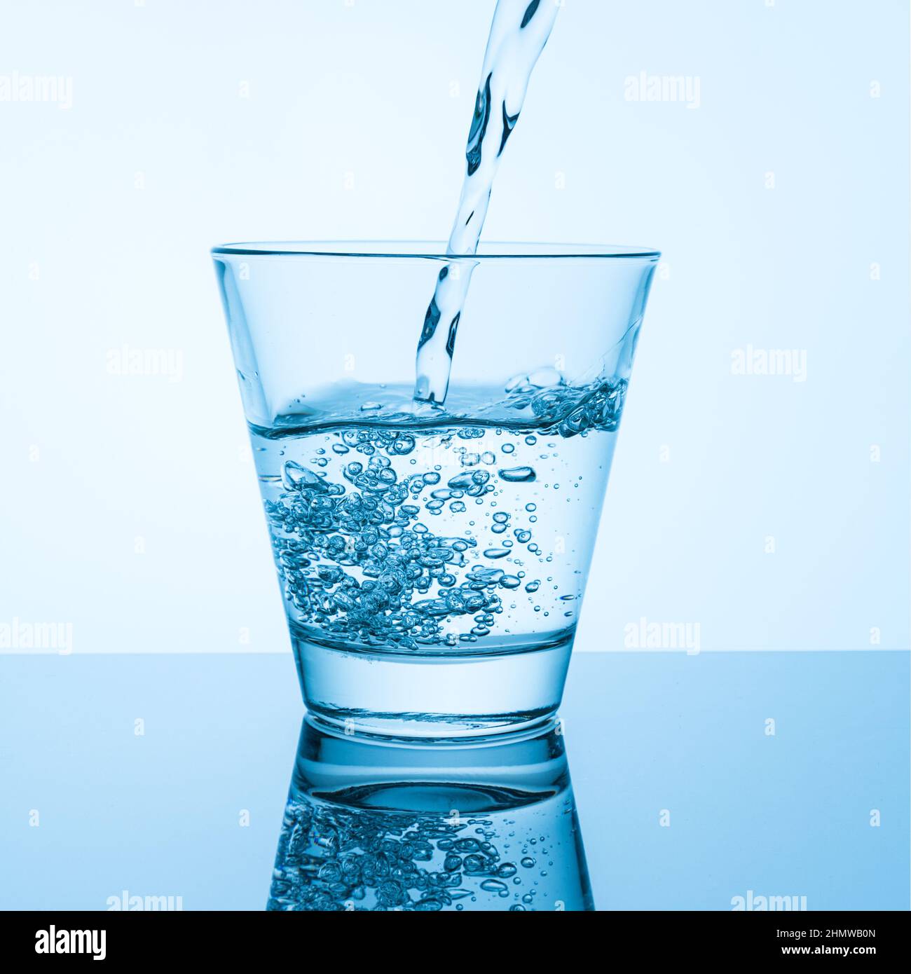 pouring water in glass Stock Photo - Alamy