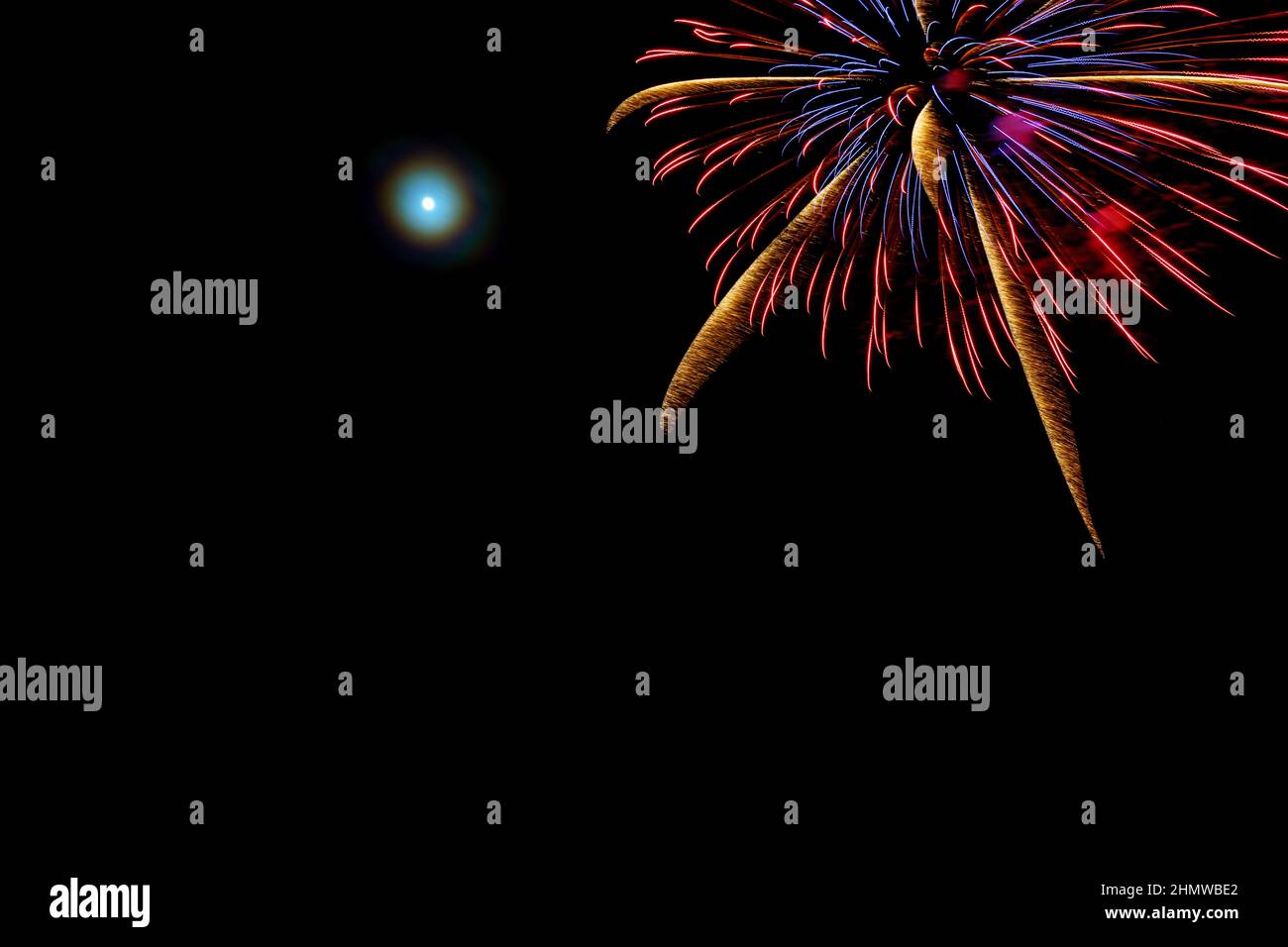 ULSTEINVIK, NORWAY- DECEMBER 31. Colorful firework with full moon next ...