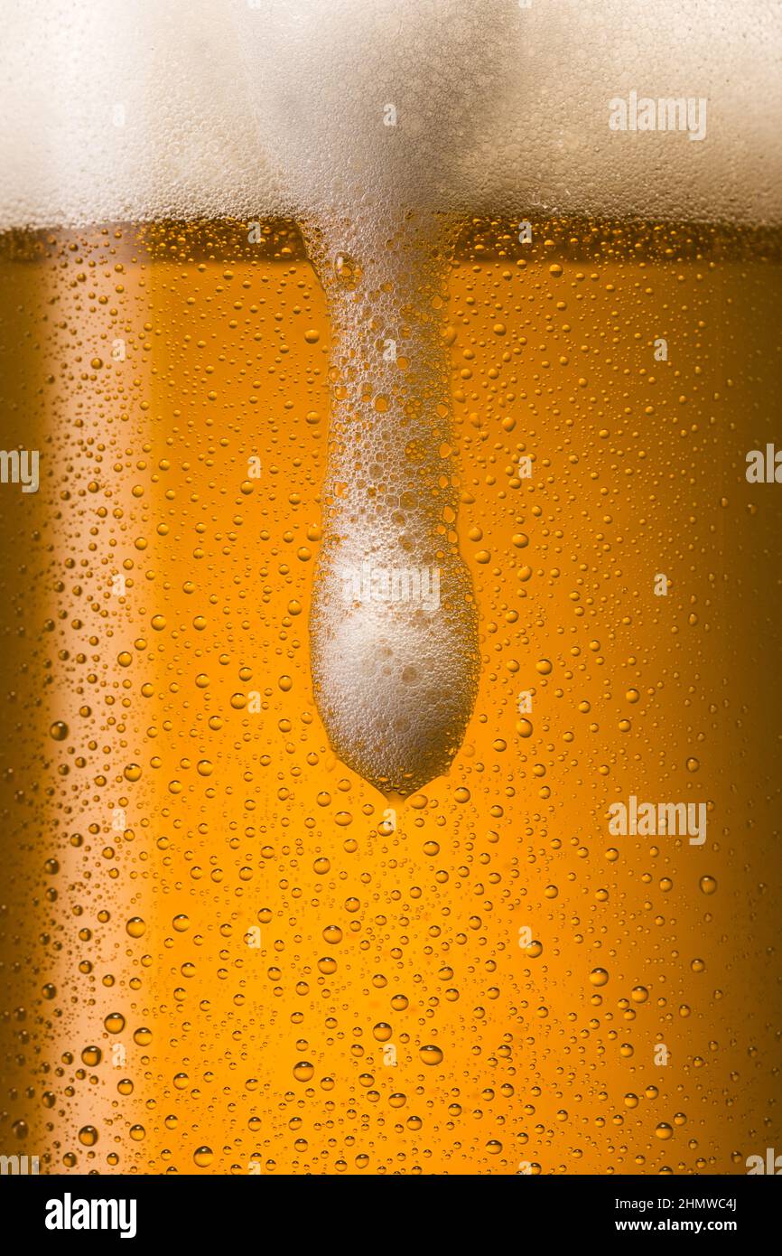 overflowing cold beer with dew drops Stock Photo - Alamy