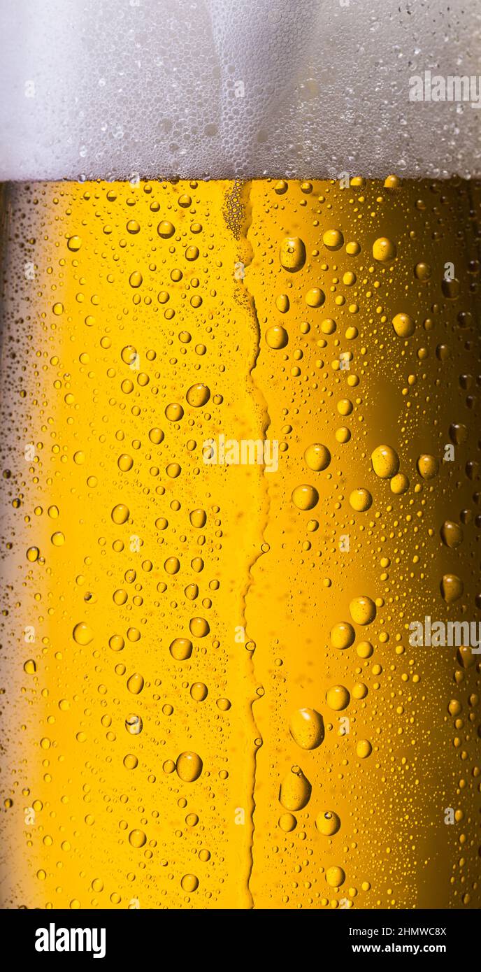 overflowing beer in a glass with dew drops Stock Photo - Alamy