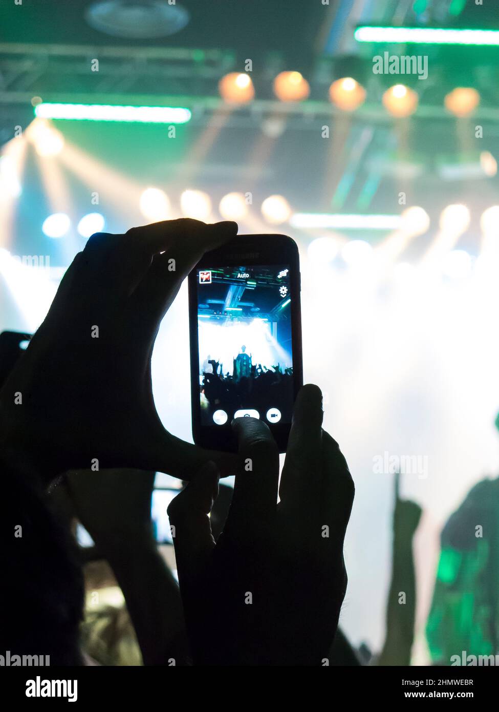 Concert spectators in front of a bright stage with live music Stock ...