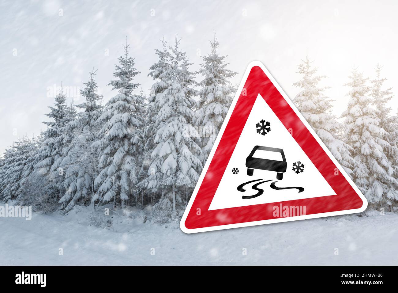 traffic sign for winter time with black ice and snow on the street and ...