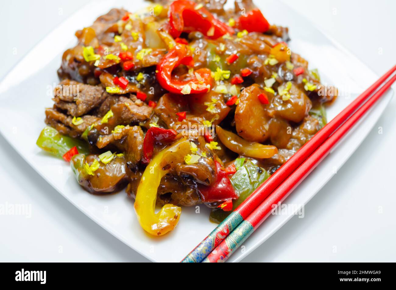 Cooked marinated beef slices with a savory black beef sauce, peppers ...