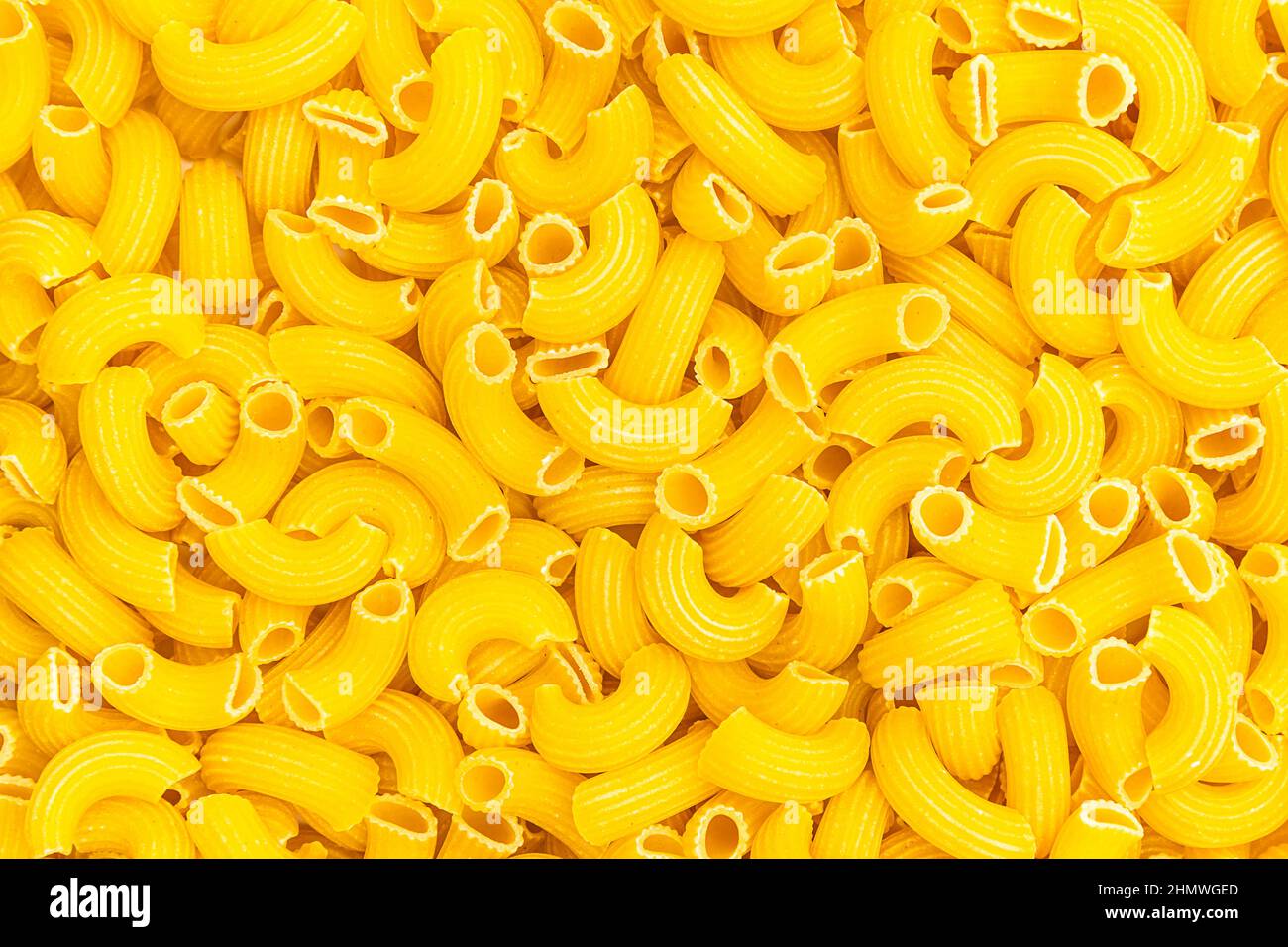 Elbow macaroni noodels background texture Stock Photo - Alamy