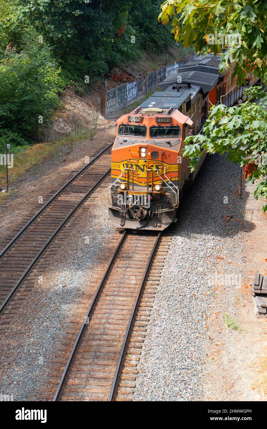 orange BNSF American freight trains from bridge above railway tracks ...