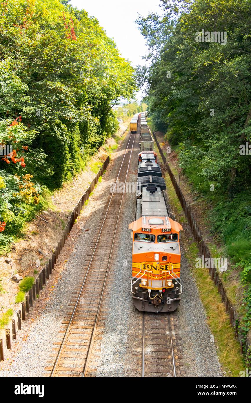 orange BNSF American freight trains from bridge above railway tracks ...