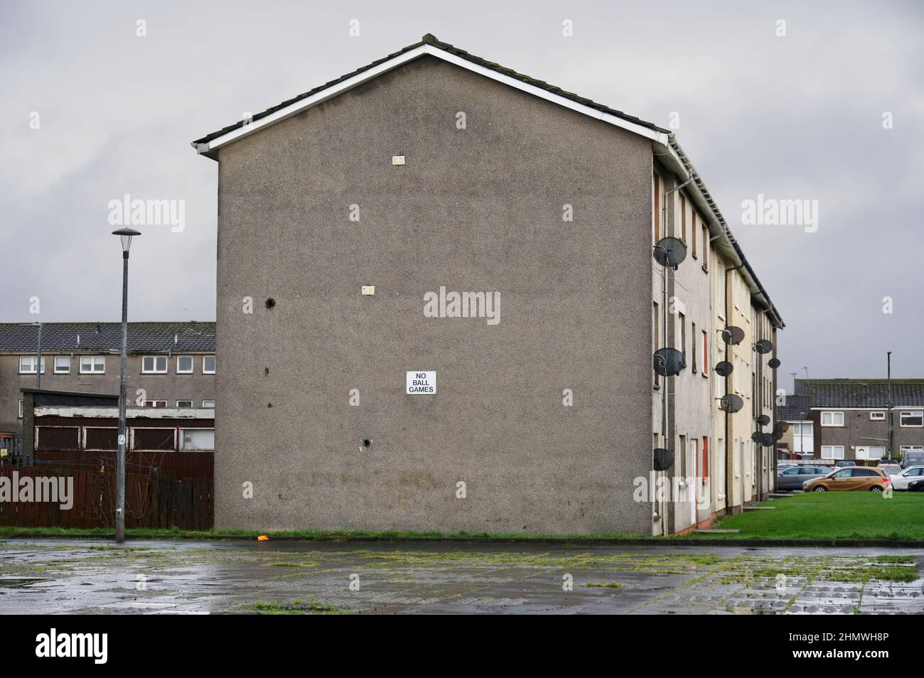 Derelict council house in poor housing estate slum with many social ...