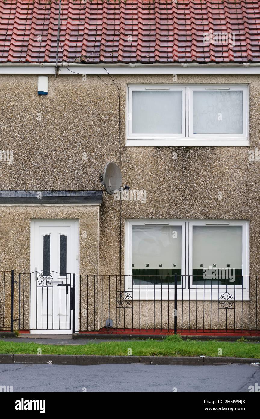 Derelict council house in poor housing estate slum with many social ...