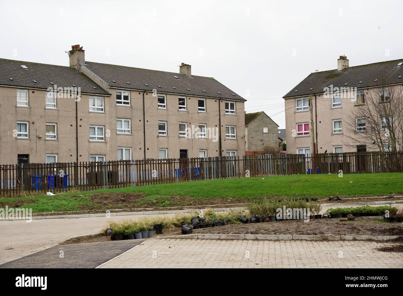 Derelict council house in poor housing estate slum with many social ...