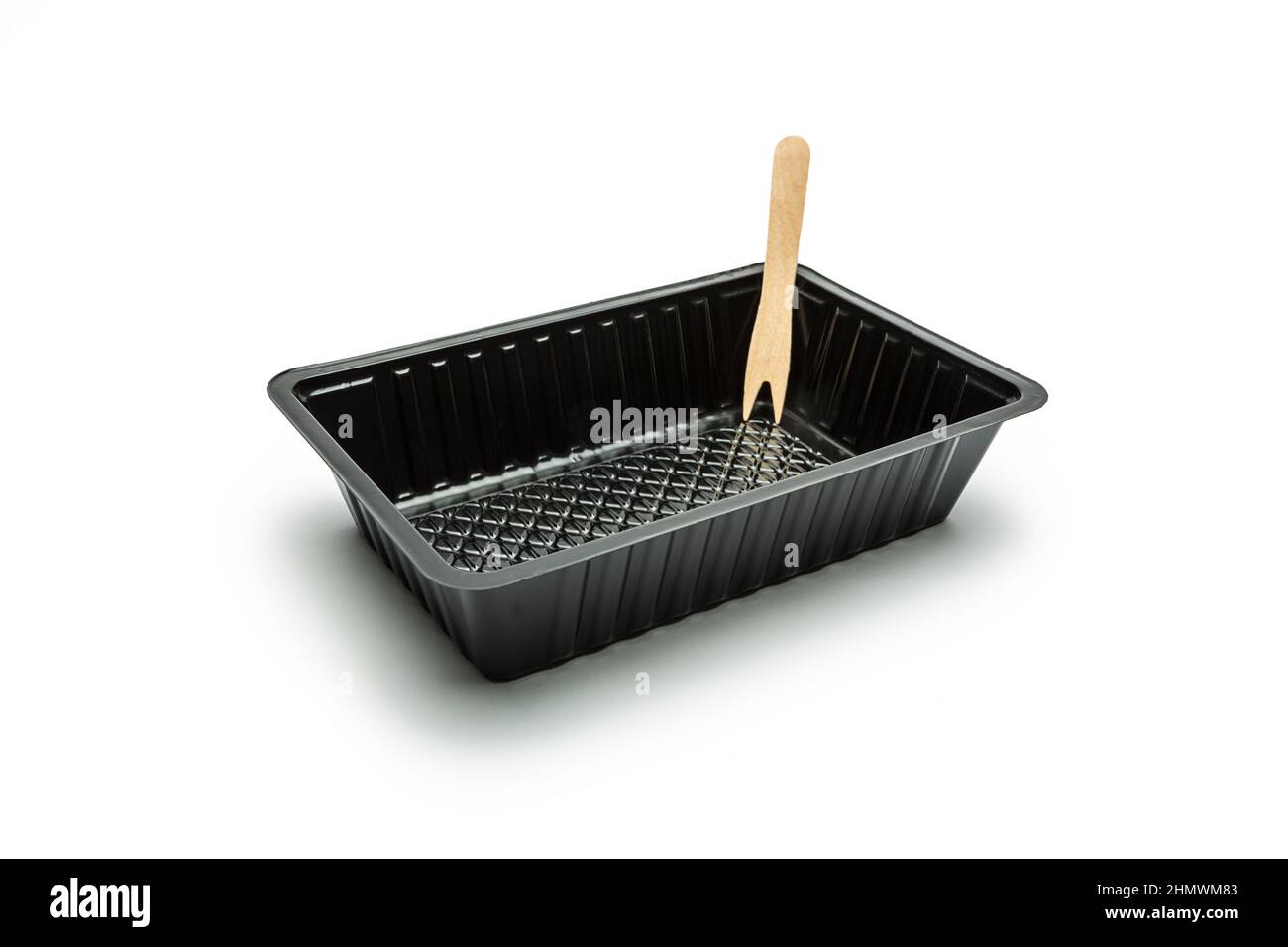 empty fries shell with wooden fork Stock Photo - Alamy