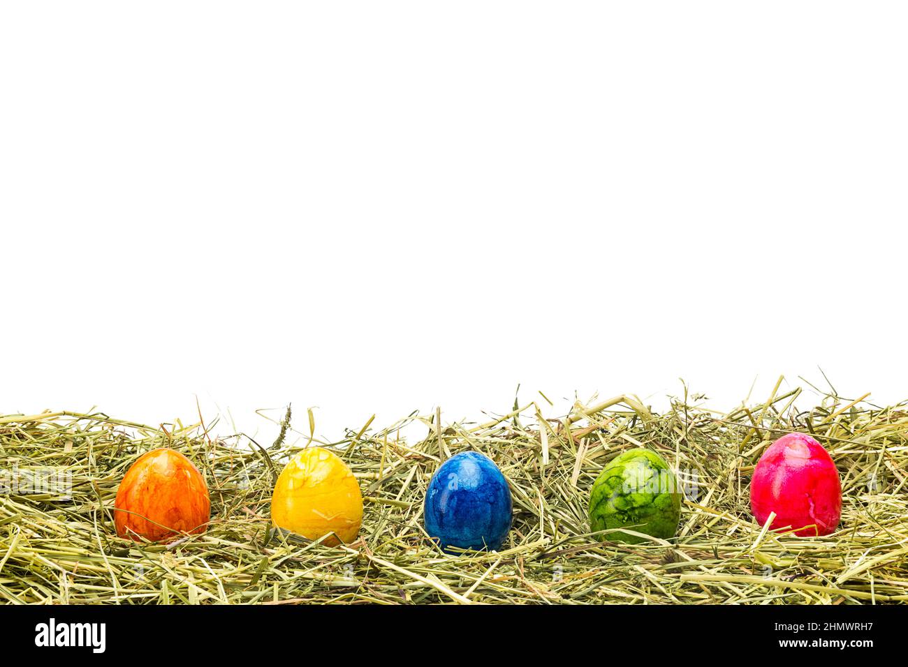 colorful easter eggs in a row on hay Stock Photo - Alamy
