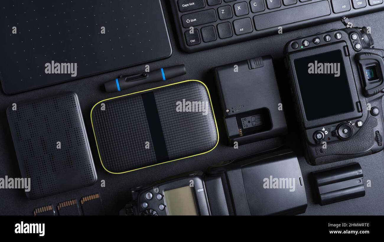 Top view of photographer work space with digital camera, flash, memory ...