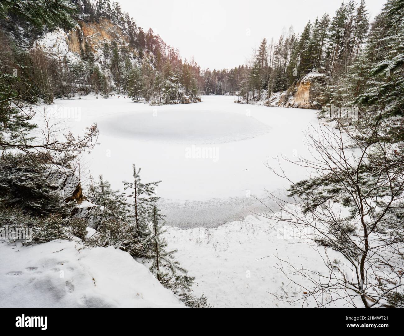Frozen blue lake in Adrspach natural park. Winter hiking in popular in ...