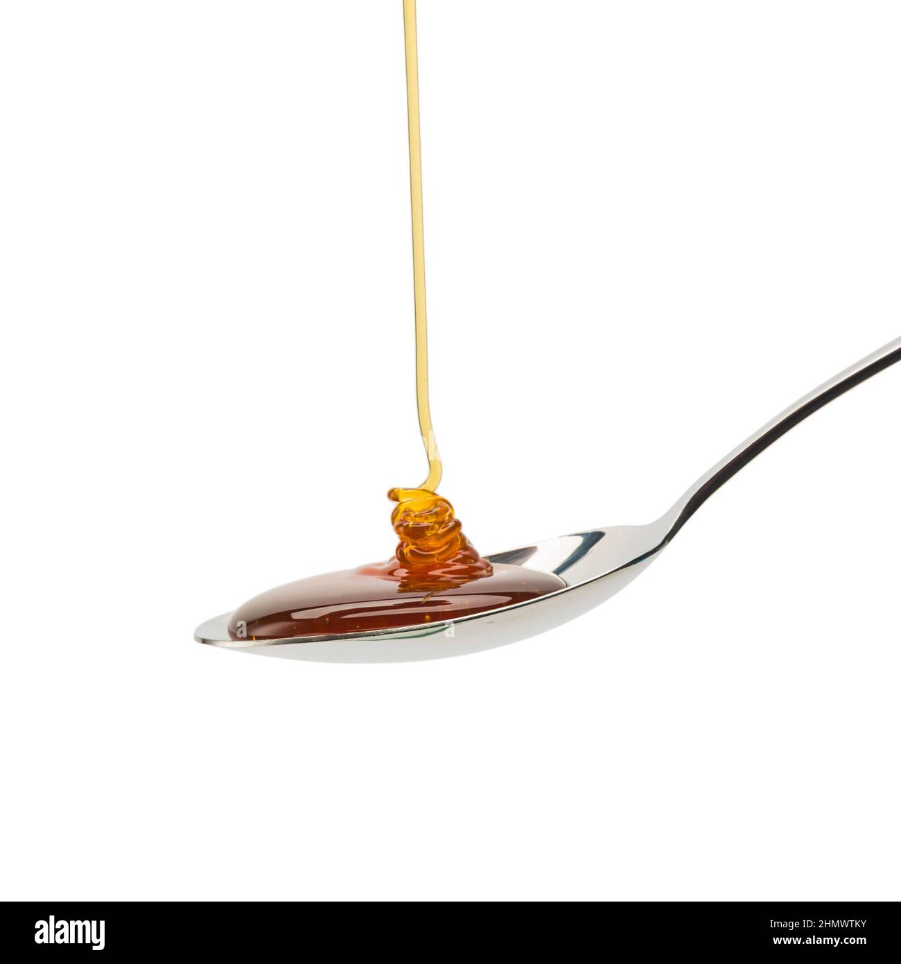 Golden syrup on a spoon hi-res stock photography and images - Alamy