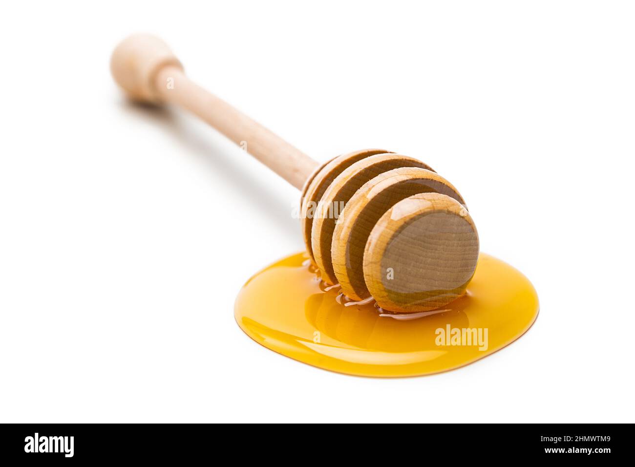 wooden honey dipper with golden honey Stock Photo - Alamy