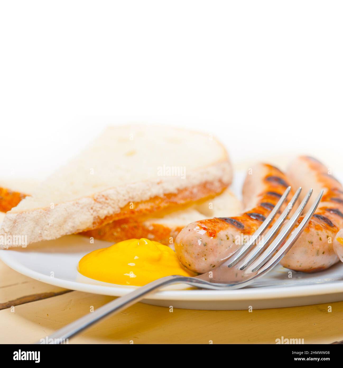 traditional fresh German wurstel sausages grilled with yellow mustard ...