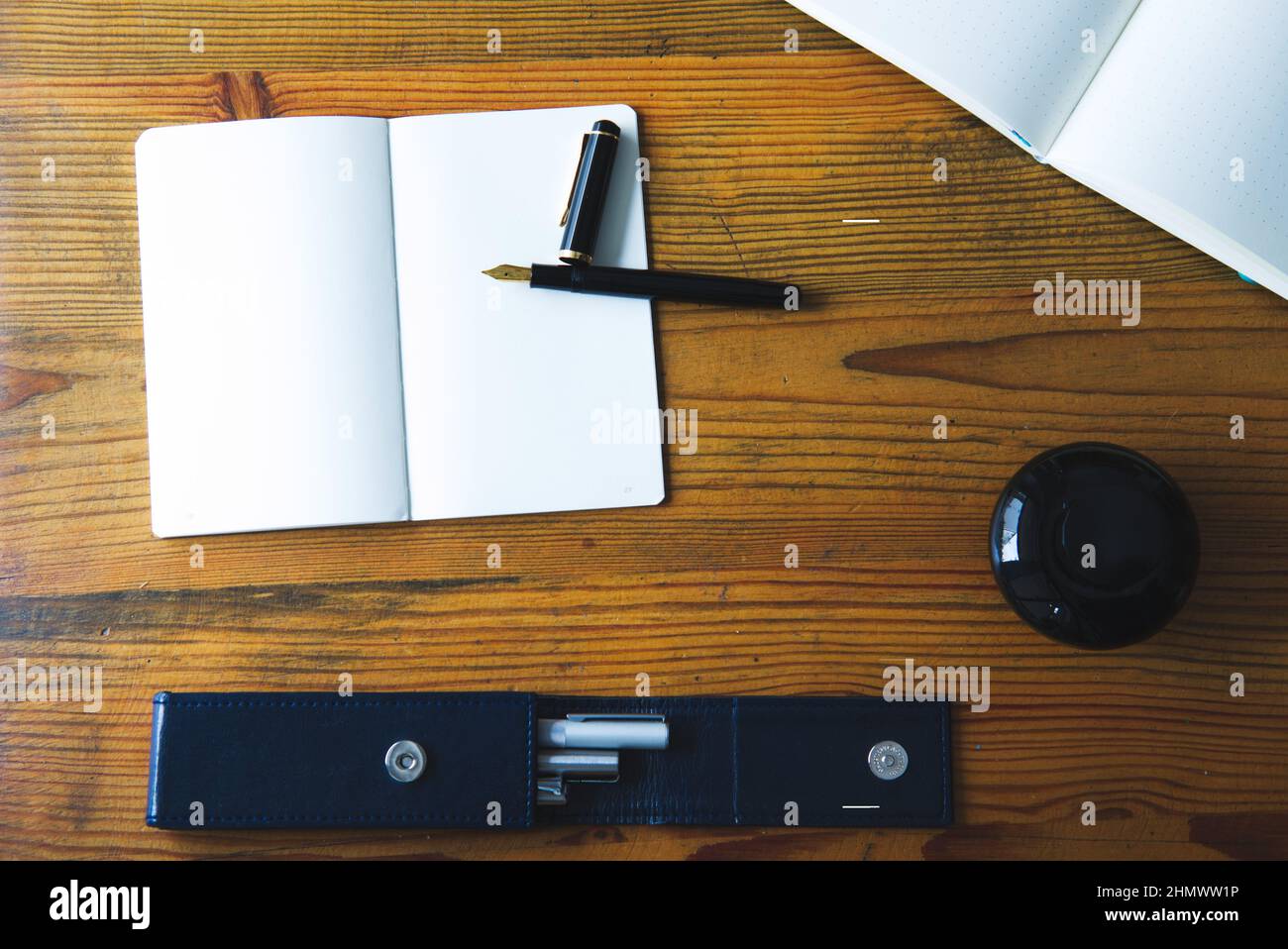 paper notebook, fountain pen and ink on wooden table - flat lay Stock ...
