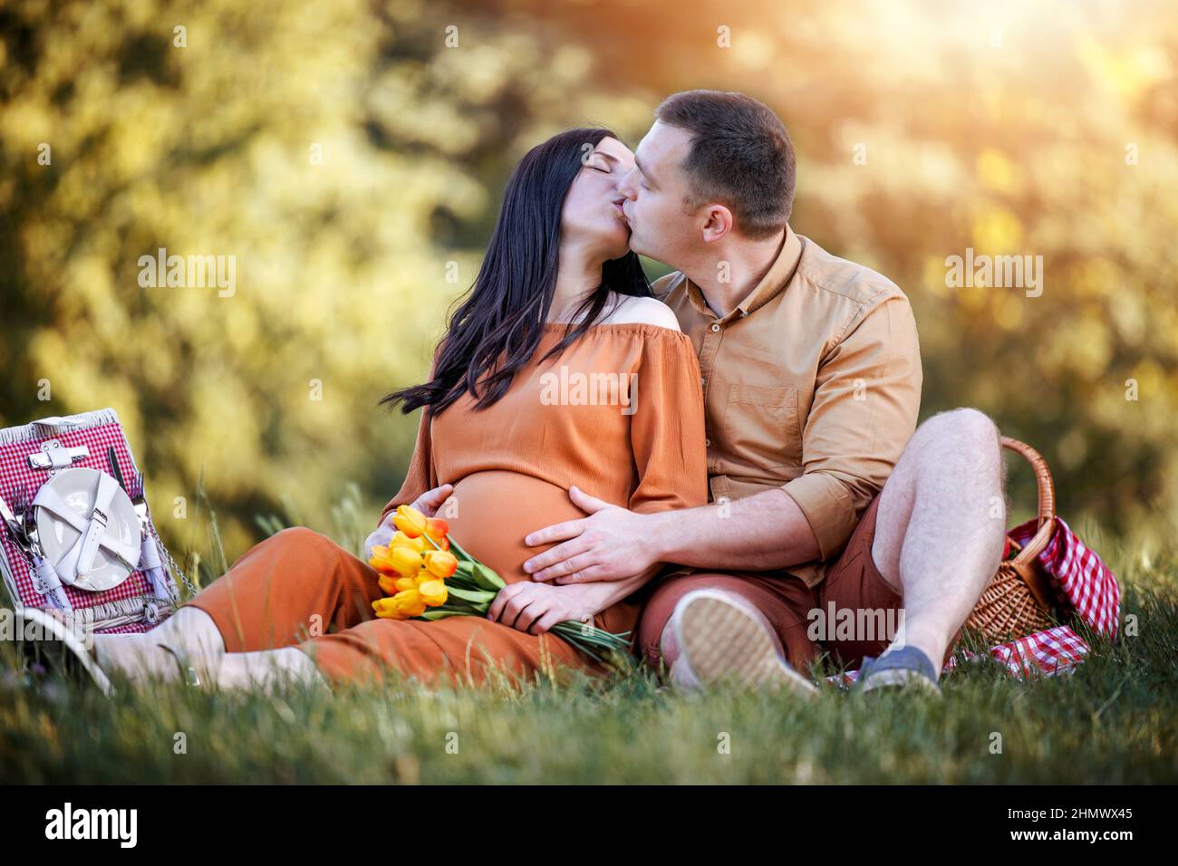Happy pregnant couple in summer park,enjoying on vacation Stock Photo ...