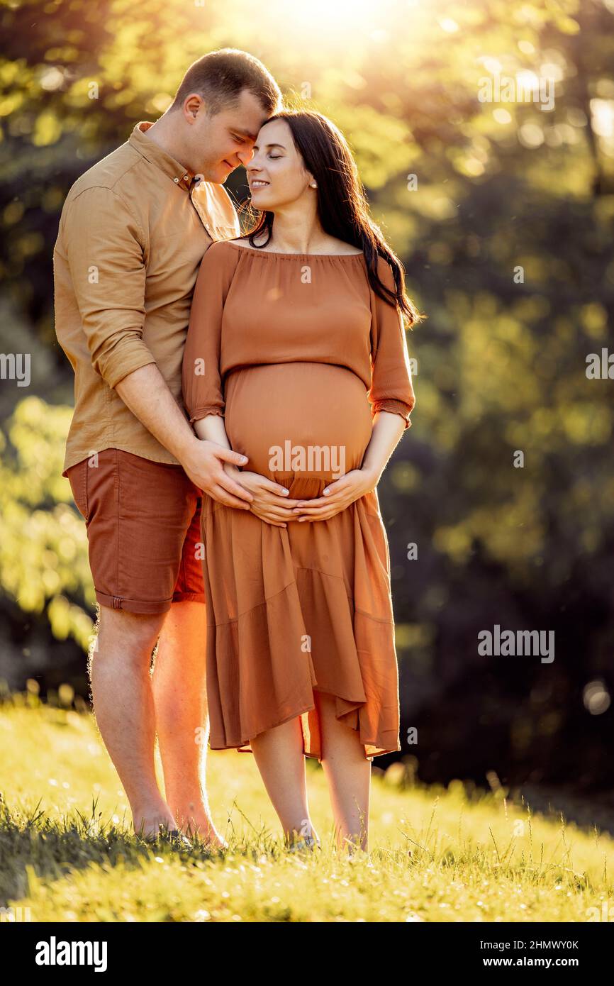 Pregnant couple hugging in nature.Husband with his pregnant wife ...