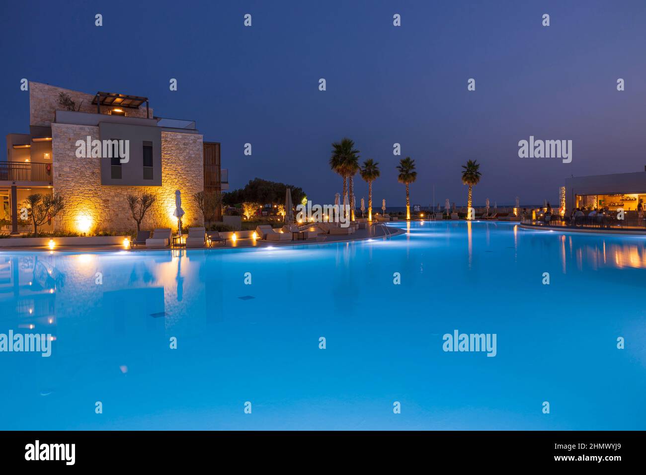 Beautiful night landscape overlooking hotel area with pool against dark ...