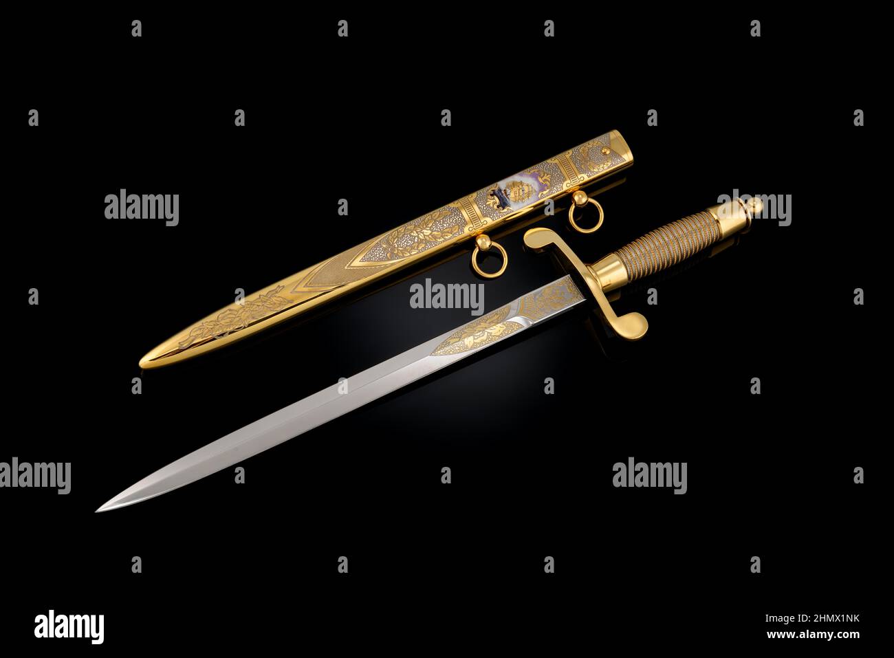 souvenir collectible silver gold dagger with scabbard on black. Luxury ...