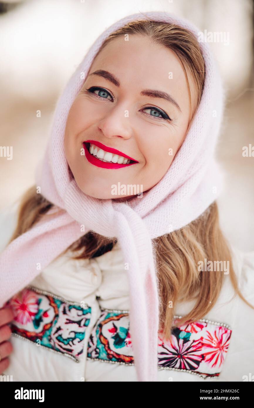 Beautiful Russian woman in a headscarf, portrait. A lovely woman smiles ...