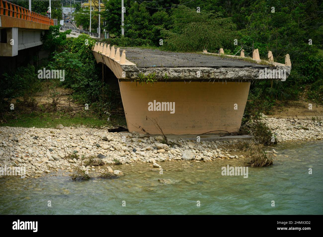 Destroyed bridge on the river. Natural landscape have done in Dominican ...