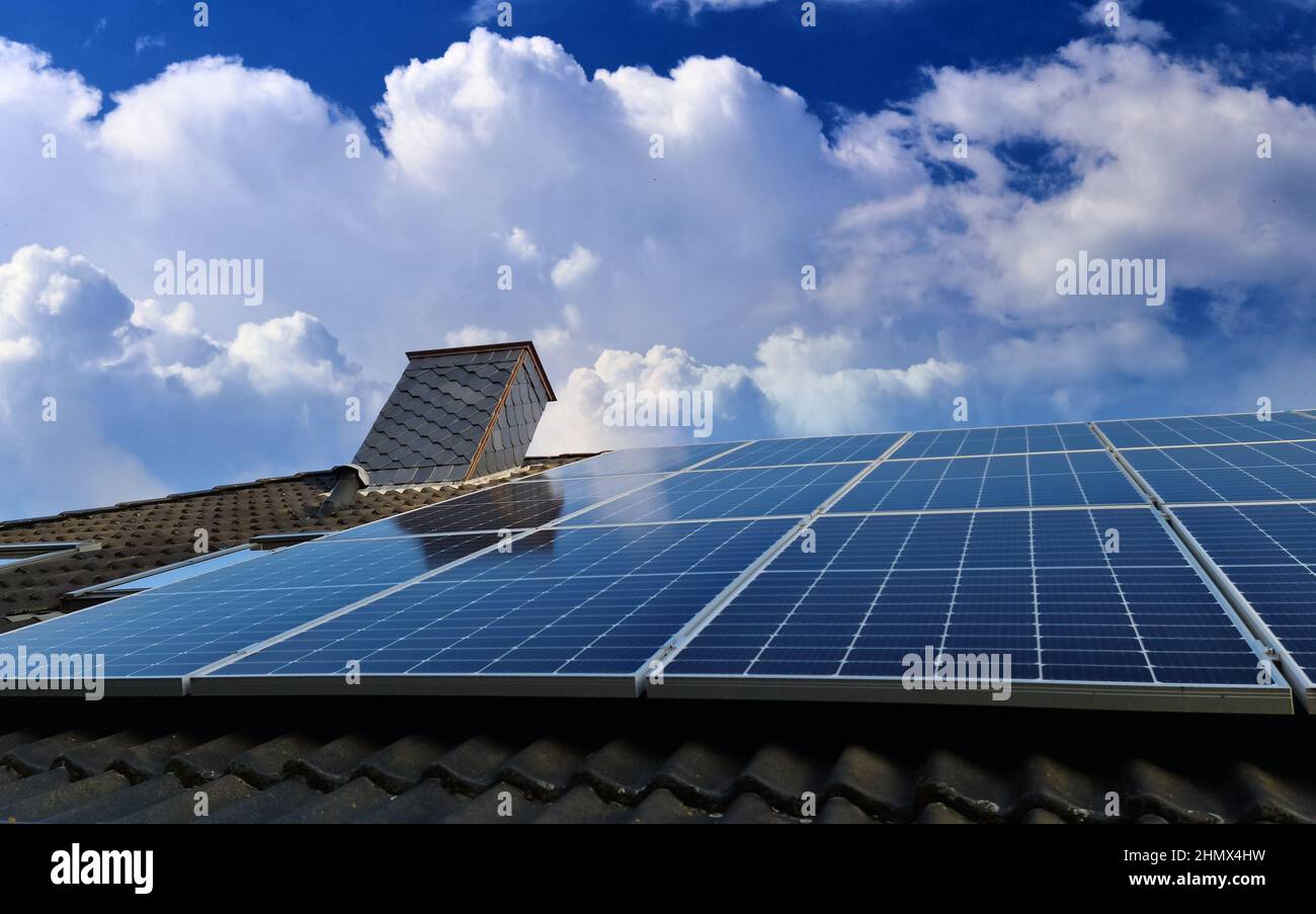 Solar panels producing clean energy on a roof of a residential house ...