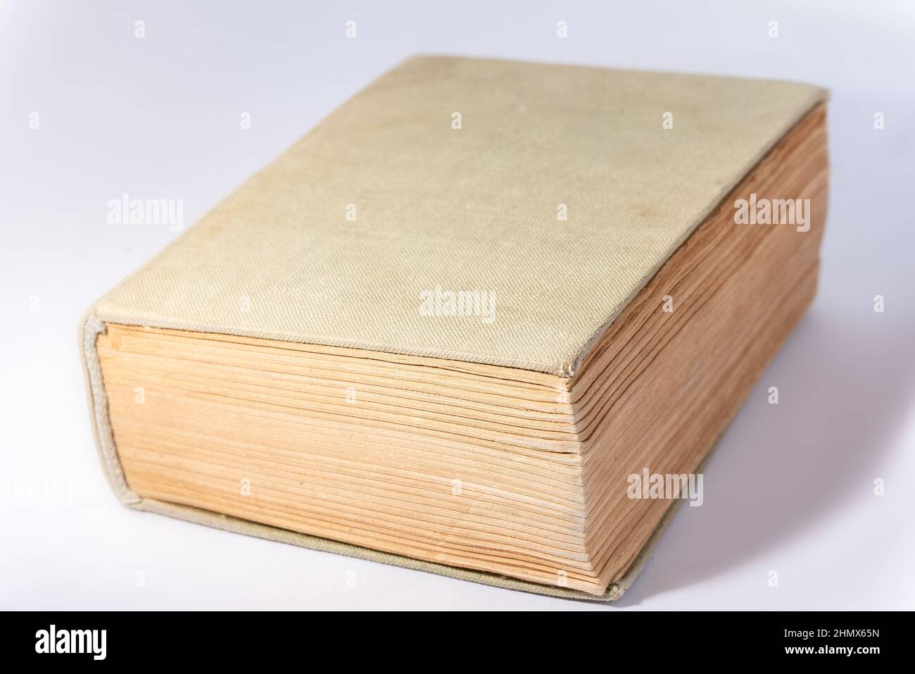 Old book with yellowed pages and a cloth cover. Thick book isolated on ...