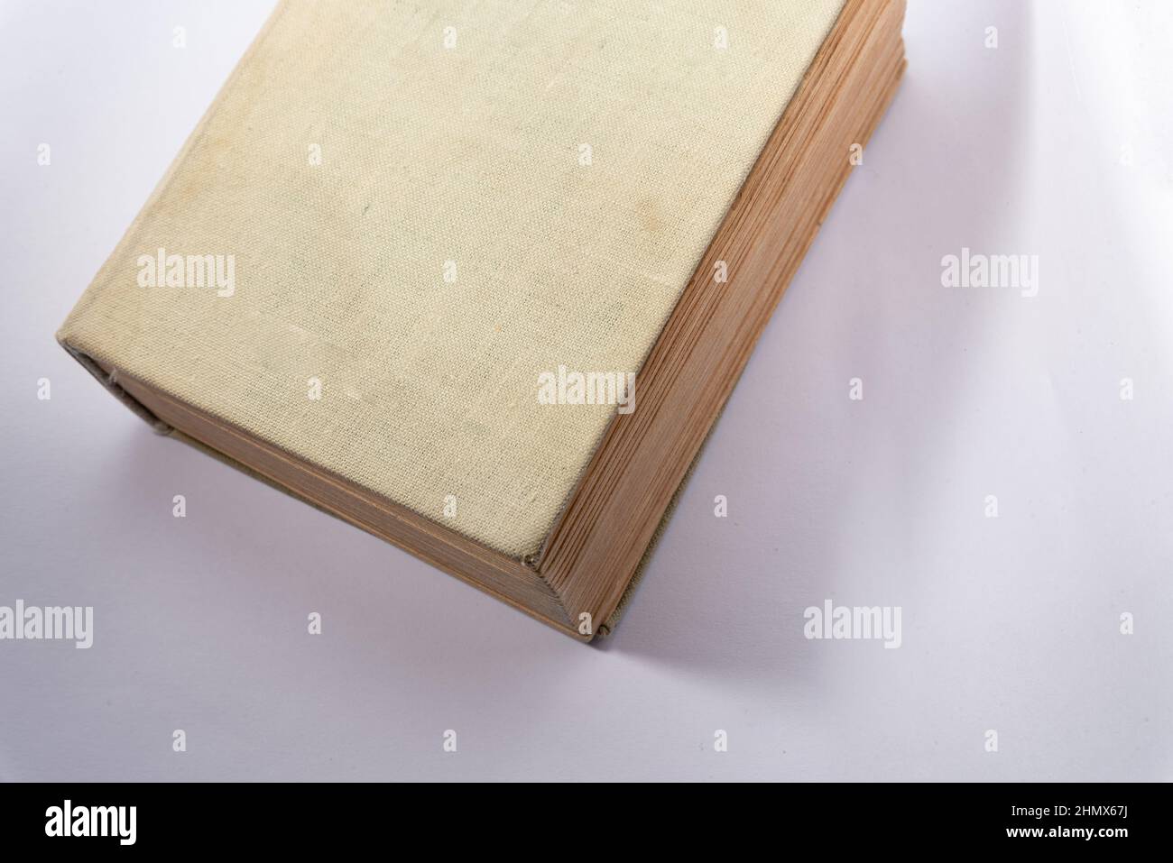 Old book with yellowed pages and a cloth cover. Thick book isolated on ...