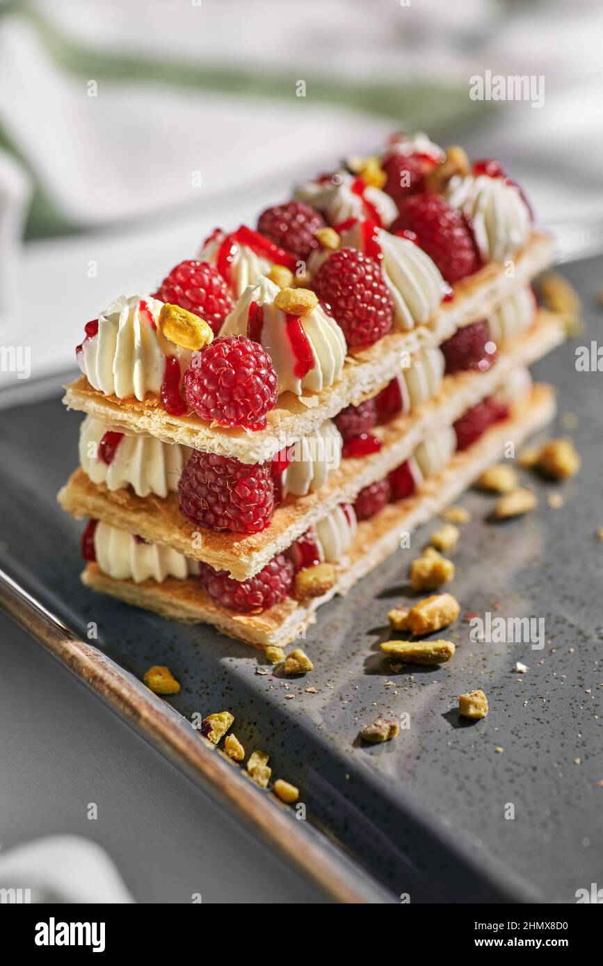 Layered cream dessert Millefeuille with vanilla cream and red berries ...