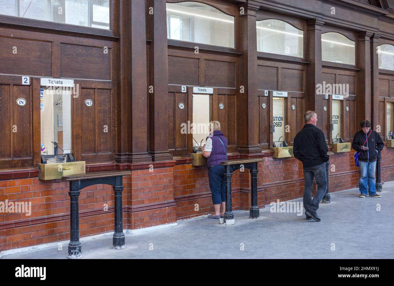 Rail passenger buying rail tickets at Manchester Victoria railway ...